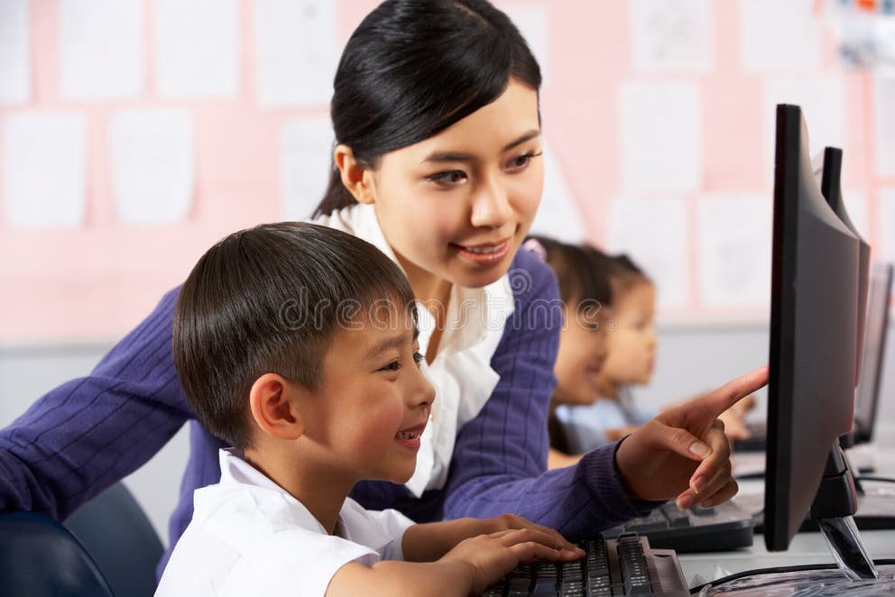 Teacher Helping Student during Computer Class Stock Image - Image of ...