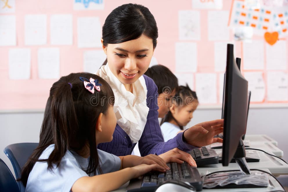Teacher Helping Student during Computer Class Stock Photo - Image of ...