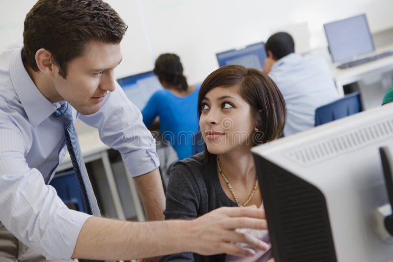 Teacher Helping Student in Computer Lab Stock Photo - Image of helping ...
