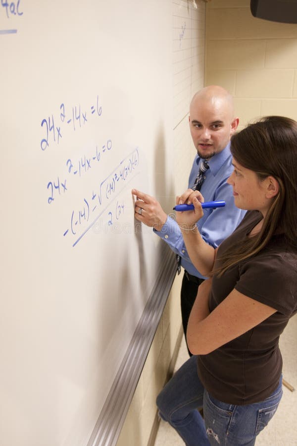 Teacher Helping Student with a Math Problem on a Whiteboard. Stock ...