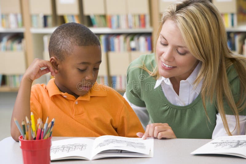 Teacher Helping Student with Reading Skills Stock Photo - Image of ...