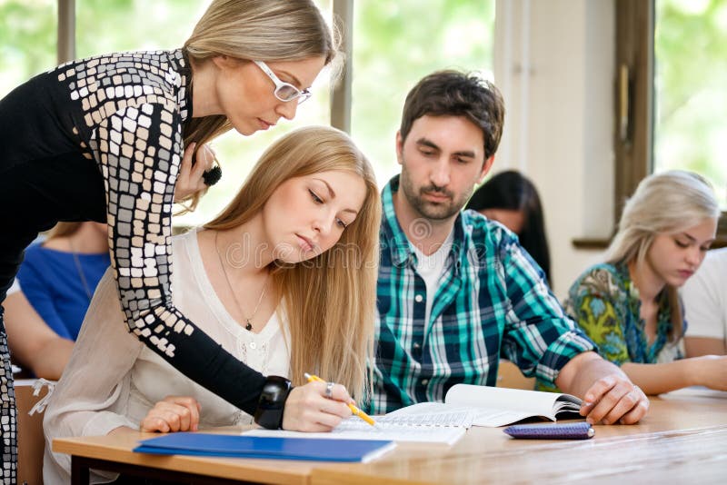 Teacher helping students stock image. Image of helping - 33256255