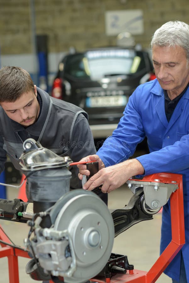 Teacher Helping Students Training To Be Car Mechanics Stock Photo ...