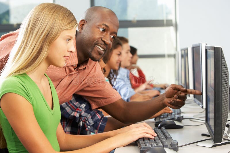 Teacher Helping Students Working at Computers in Classroom Stock Photo ... Teacher Helping Students Working at Computers in Classroom Stock Photo ...