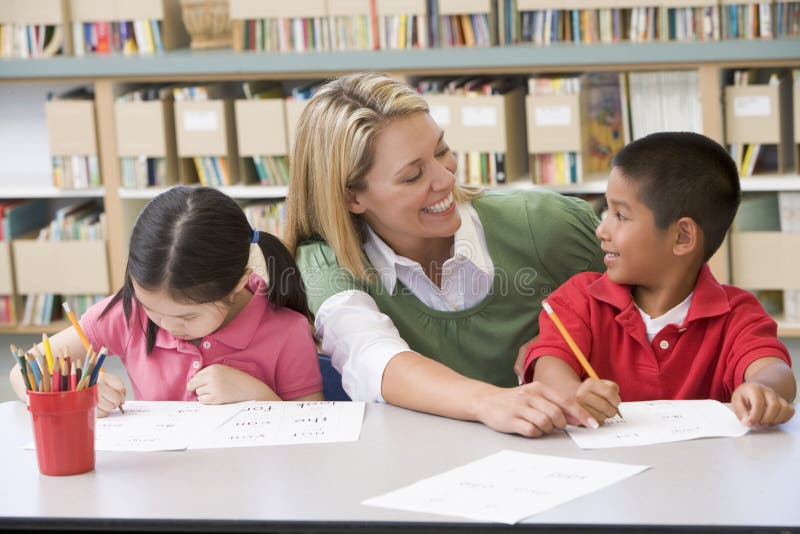 Teacher Helping Students with Writing Skills Stock Image - Image of ...