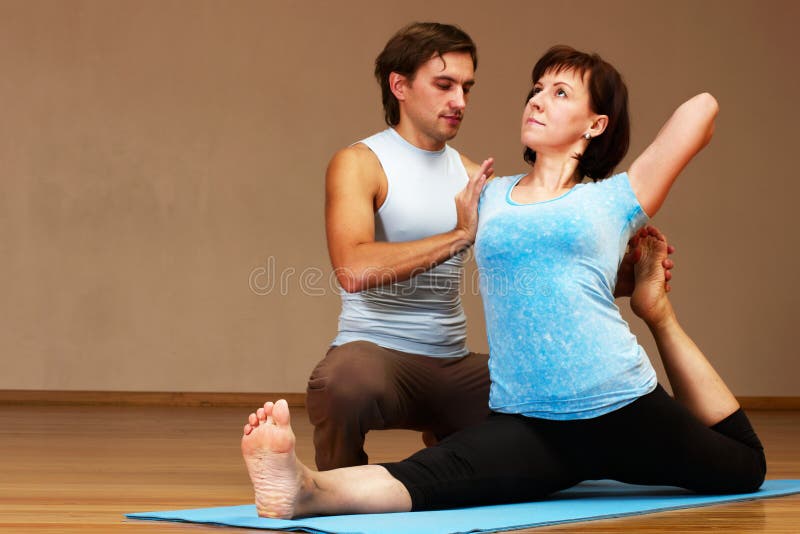 Teacher Helping with Yoga Pose Stock Image - Image of adult, male: 12407215