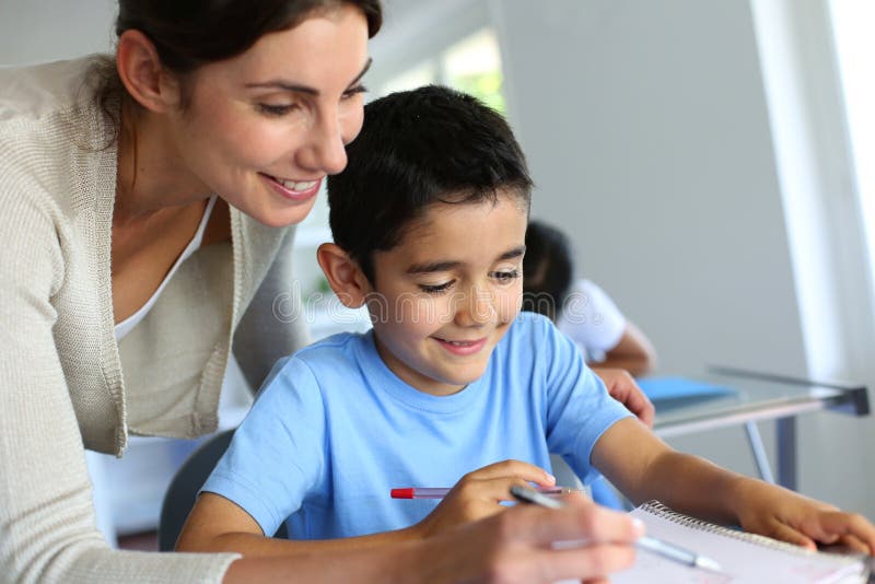 Teacher Helping Young Boy Writing Stock Image - Image of preschool ...