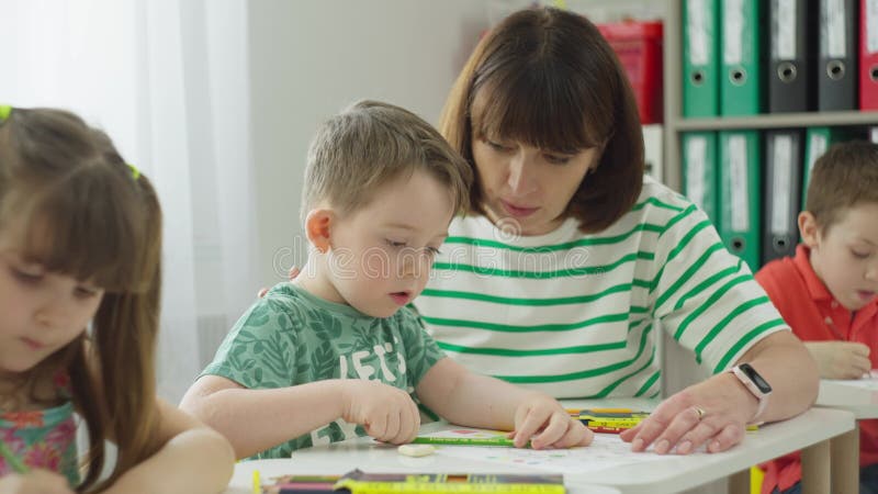 The Teacher Helps the Boy with an Individual Task. Stock Footage ...
