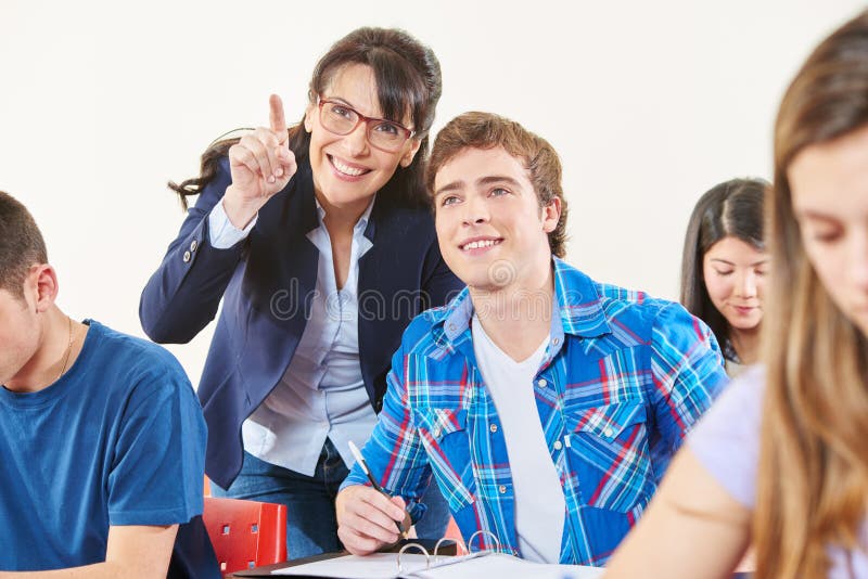 Teacher helps a student stock image. Image of support - 70839401