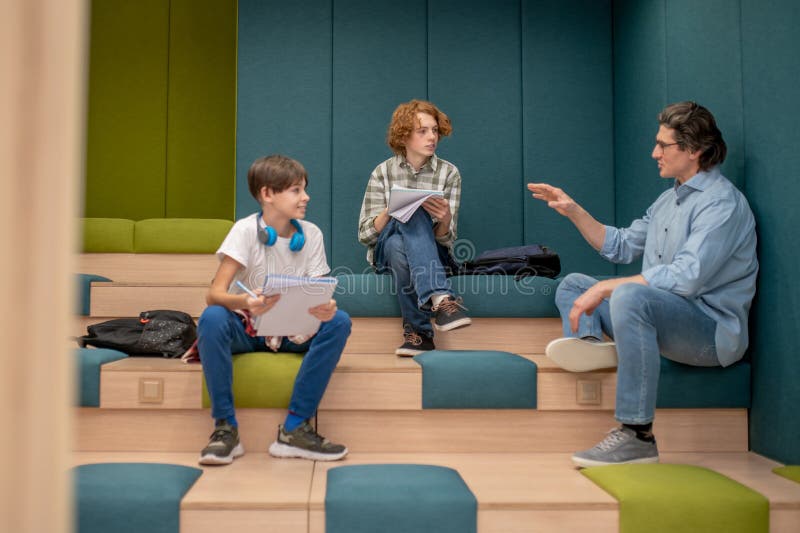 A Teacher and His Students Discussing Details of the Project Stock ...