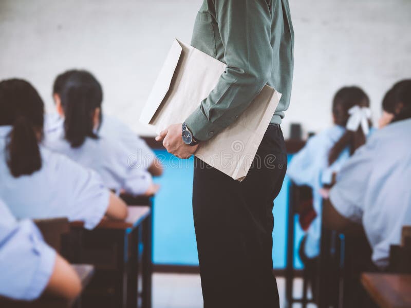 The Teacher Holds the Exam Paper and Controls the Exam Room while the ...