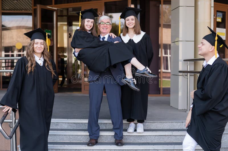 The Teacher Holds the Graduate in His Arms. Stock Image - Image of girl ...