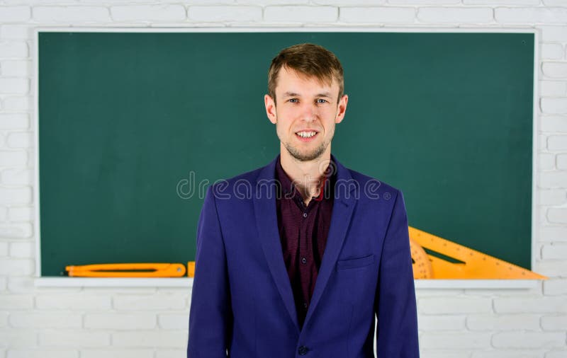Teacher Introduced To Class Young Man at Chalkboard, School Year ...