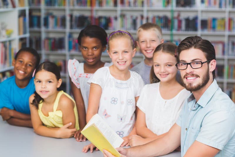 Teacher and Kids Lying on Floor Using Digital Tablet in Library Stock ...