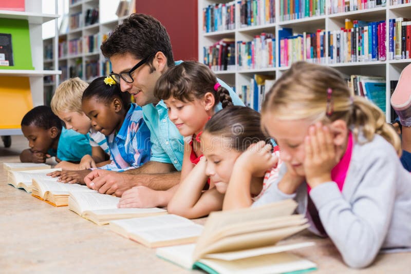 Teacher and Kids Reading Book in Library Stock Photo - Image of ...