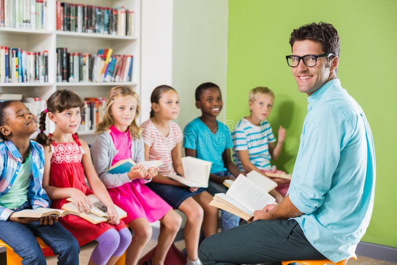 Teacher and Kids Reading Book in Library Stock Photo - Image of ...