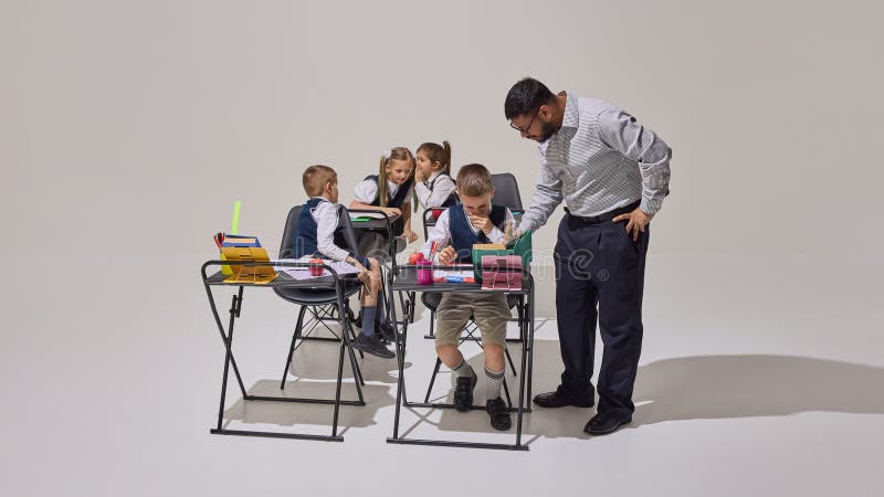 Teacher Leading Lesson for Elementary School Pupils, Helping in Doing ...