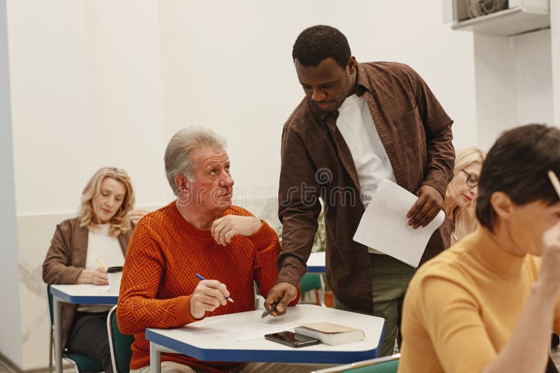 Teacher Making Exam for Adult Students Stock Photo - Image of caucasian ...