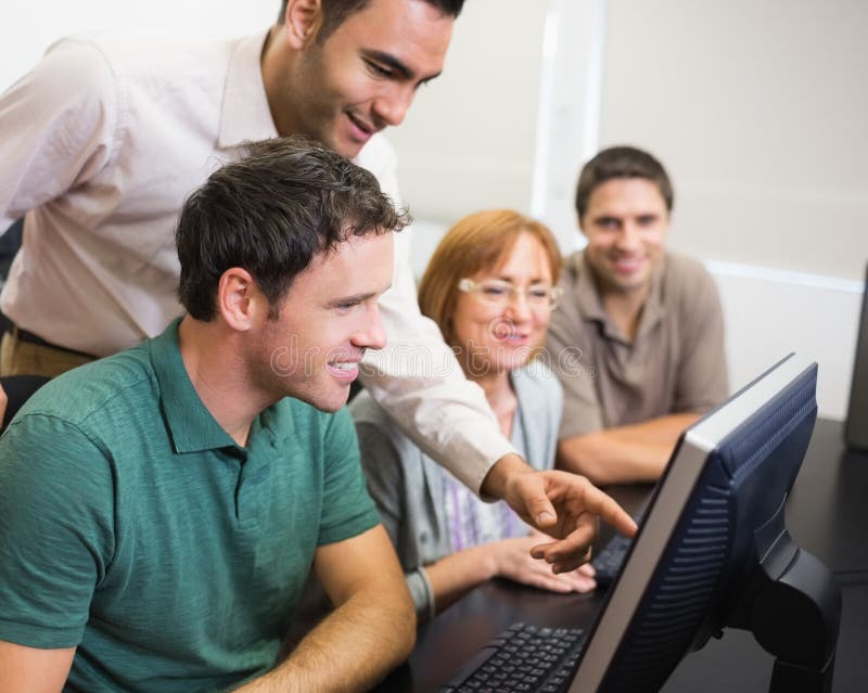 Teacher Assisting College Student in Computer Lab Stock Image - Image ...