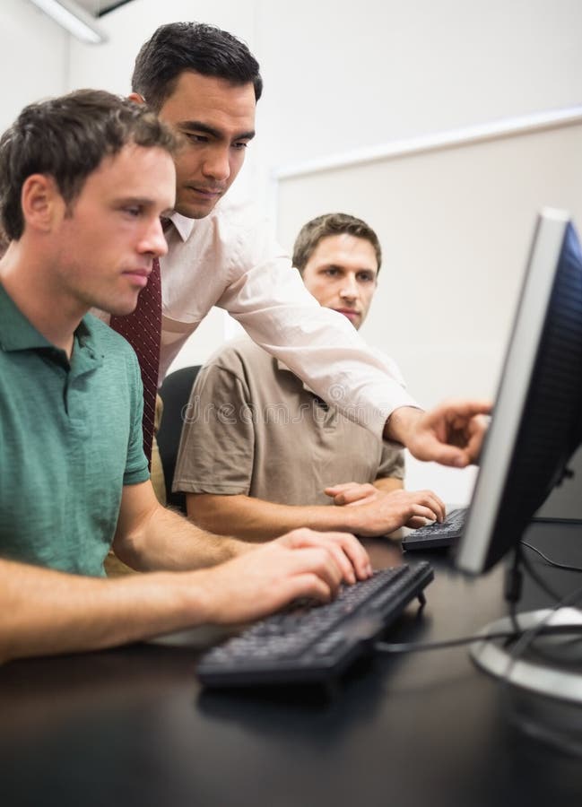 Teacher and Mature Students in Computer Room Stock Image - Image of ...