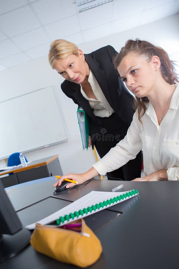 Teacher Observing Female Student Stock Photo - Image of browsing ...
