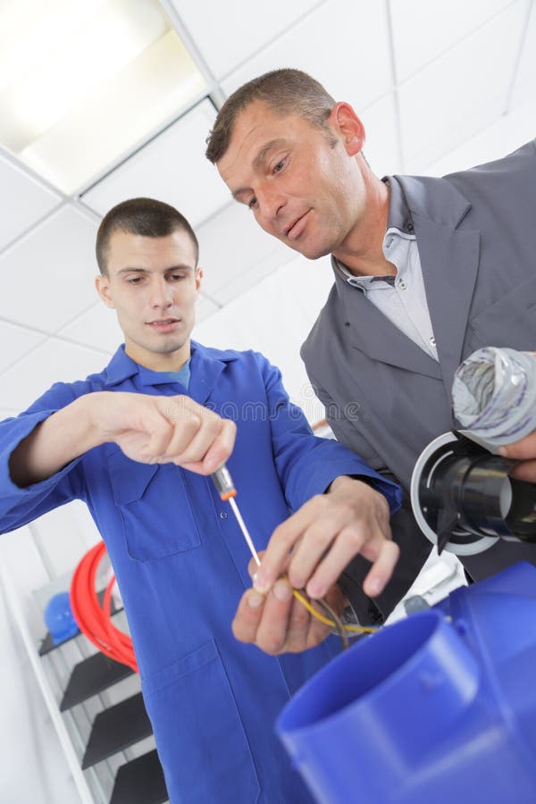 Teacher Observing Student Working on Electrical Circuits Stock Photo ...