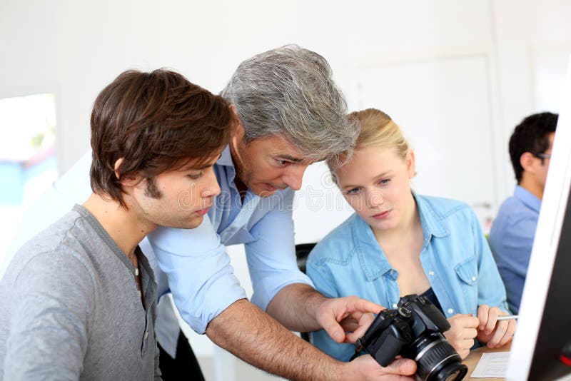 Teacher in Photography Class Showing Camera Stock Image - Image of ...