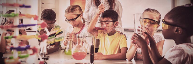A Teacher Posing with Pupils Doing Science Project Stock Image - Image ...