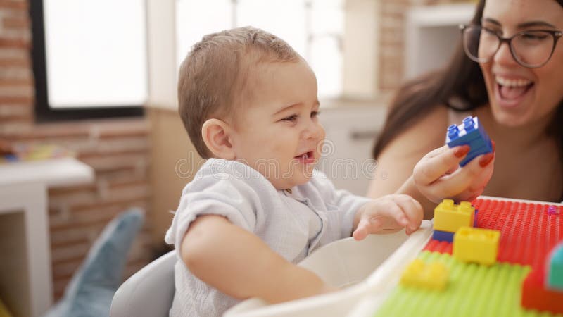Teacher and Preschool Student Playing with Construction Blocks Sitting ...