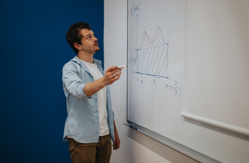 Educator Explaining Graph on Whiteboard in Classroom Setting Stock ...