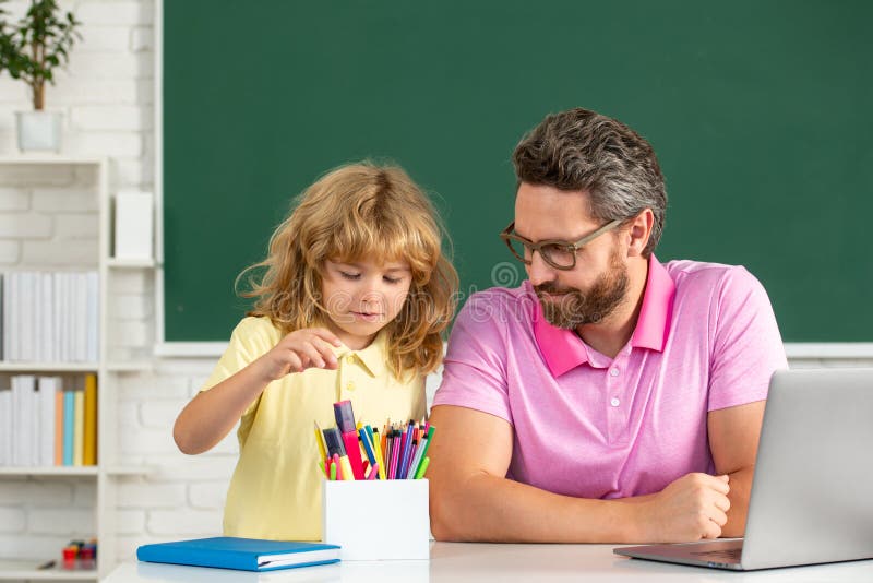 Teacher and Pupil Boy Learning in the Classroom. Cute Elementary School ...