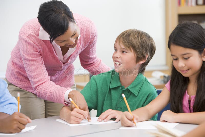 Elementary School Pupils In Classroom Stock Photo - Image of discussing ...
