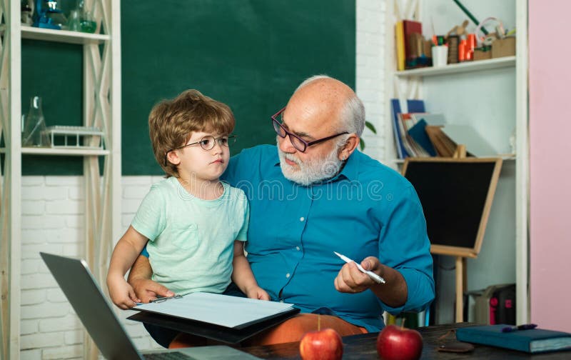 Teacher and Pupil Learning Together in School. Back To School. Stock ...