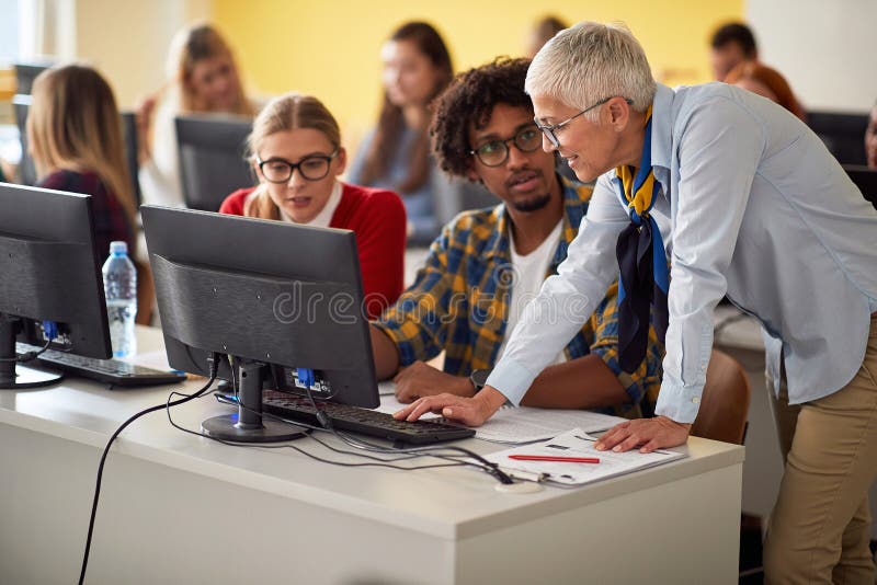 Teacher with Pupil Looking at Computer Stock Image - Image of desk ...