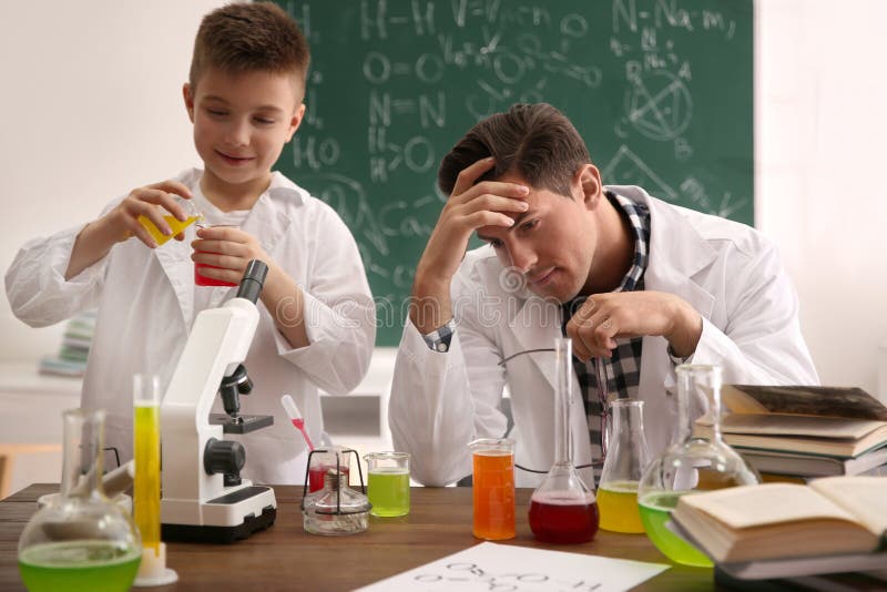 Teacher with Pupil Making Experiment at Table in Class Stock Image ...