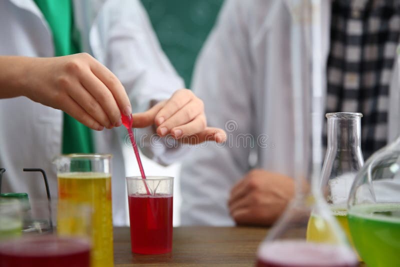 Teacher with Pupil Making Experiment at Table in Chemistry Class Stock ...