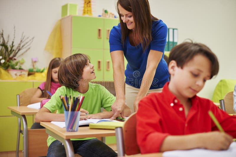 Teacher with pupils stock photo. Image of classroom, helping - 56438272
