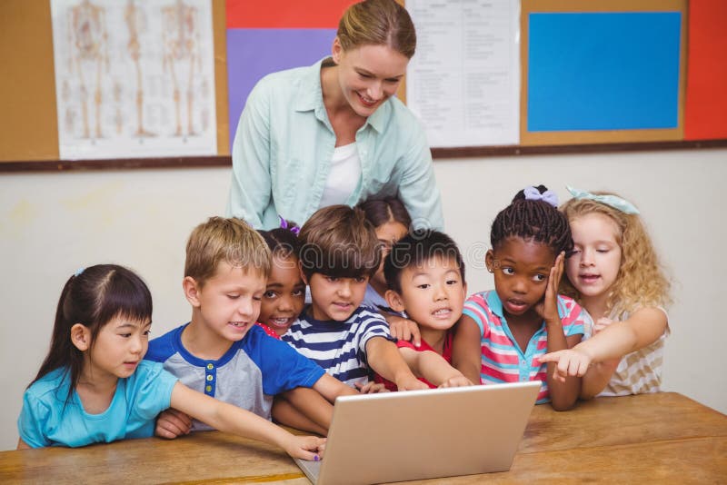 Teacher and Pupils Looking at Laptop Stock Image - Image of classroom ...