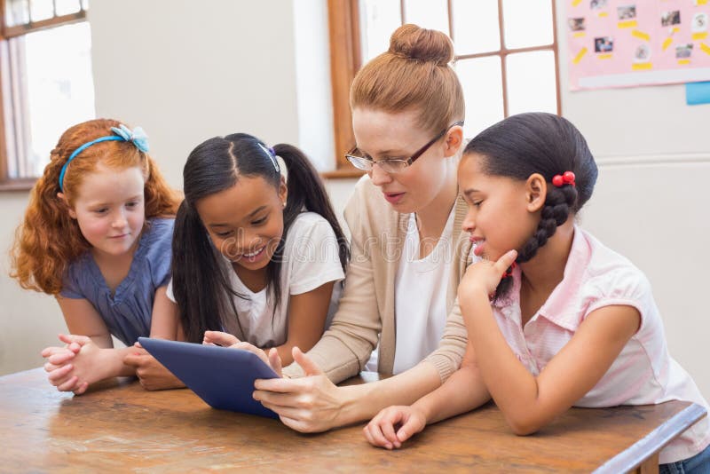 Teacher and Pupils Looking at Tablet Computer Stock Photo - Image of ...