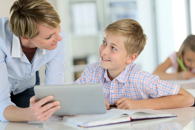 Two Students Watching Tablet while Professor Giving Lecture Stock Photo ...