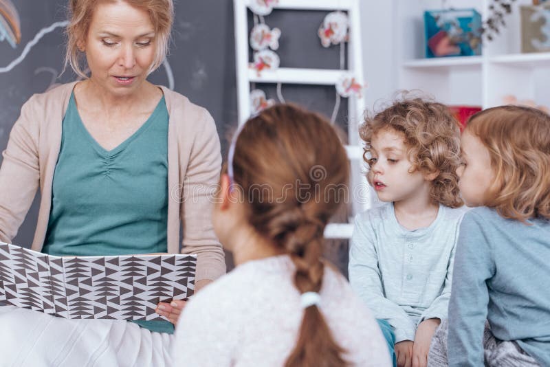 Teacher Reading Book in Kindergarten Stock Image - Image of book ...