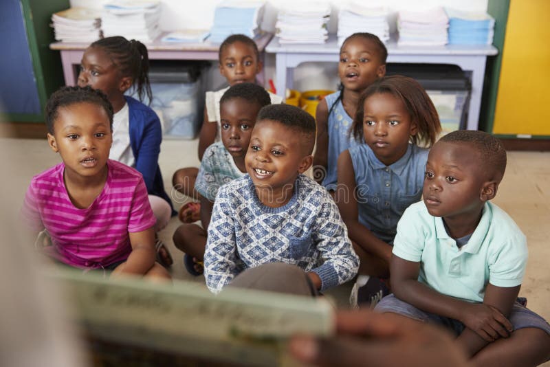 Teacher Reading Book To Elementary School Children in Class Stock Image ...