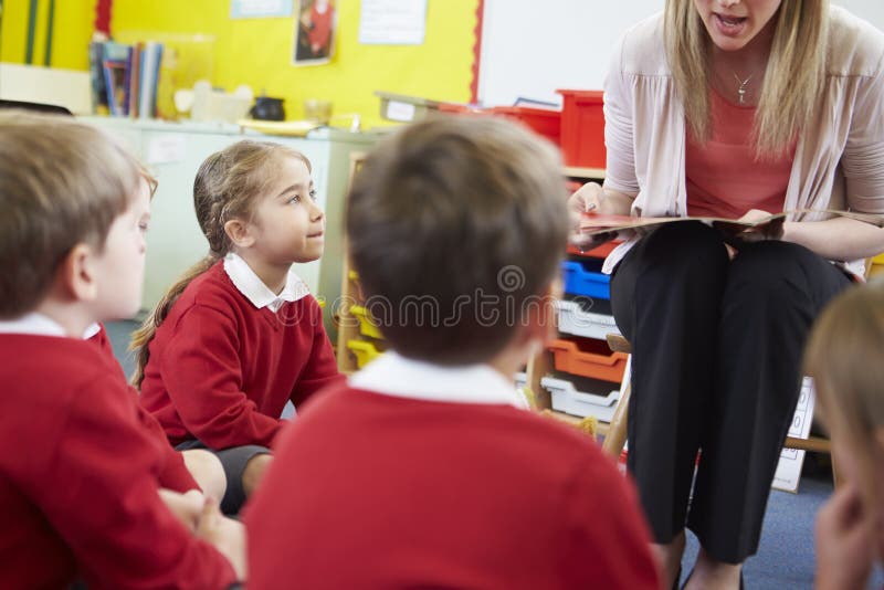 Teacher Reading Story To Elementary School Pupils Stock Image - Image ...