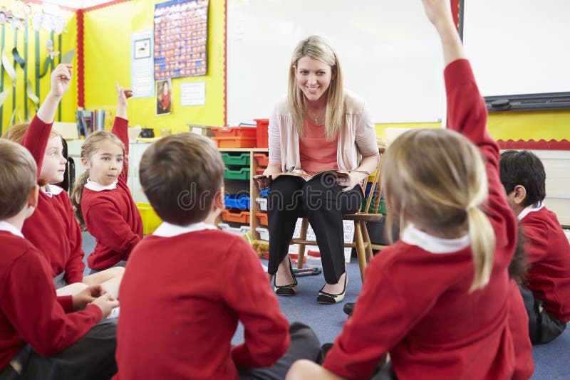 Teacher Reading Story To Elementary School Pupils Stock Photo - Image ...
