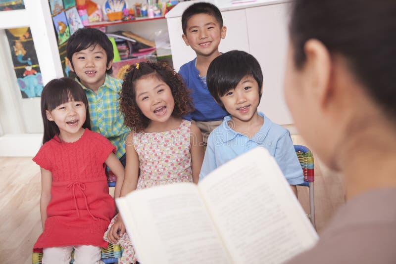 Teacher Reading To Her Students Stock Image - Image of china, chair ...