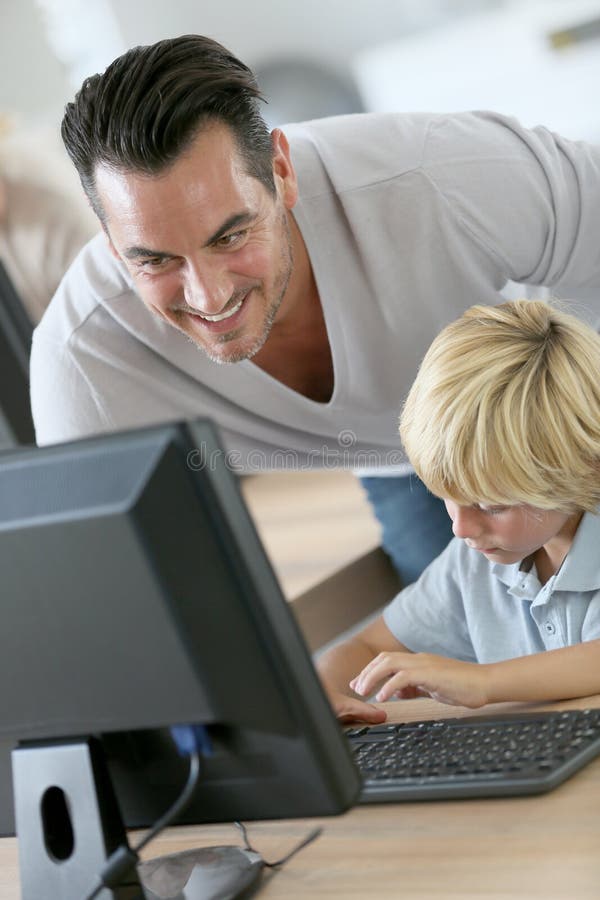 Teacher with School Boy on Desktop Computer Stock Photo - Image of ...