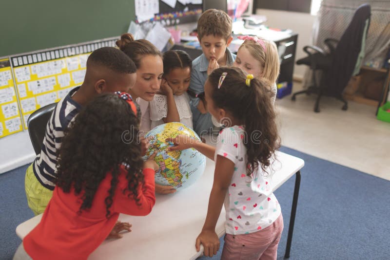 Teacher Interacting with Schoolboy in Classroom Stock Image - Image of ...