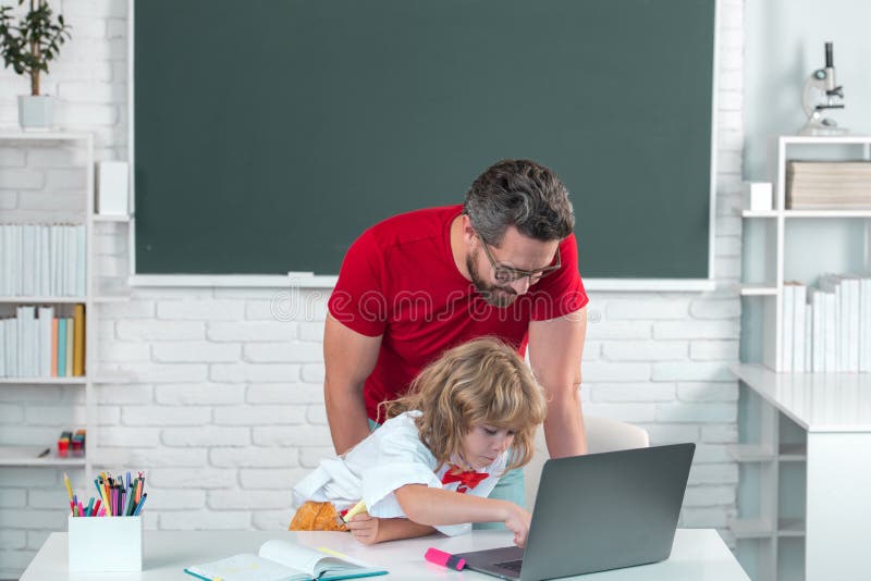 Teacher and Schoolboy Learning in Class at School. Pupil of Primary ...