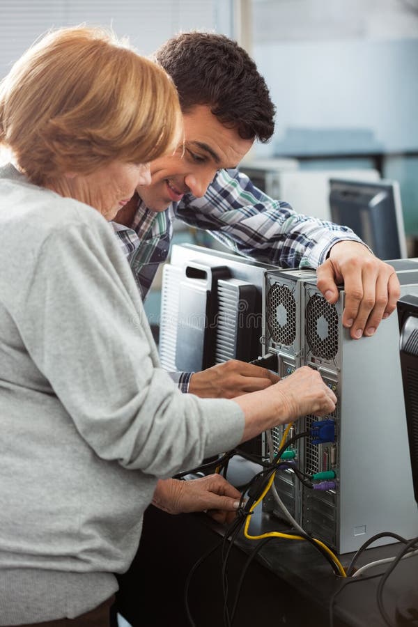 Teacher and Senior Student Setting Up Computer Stock Photo - Image of ...