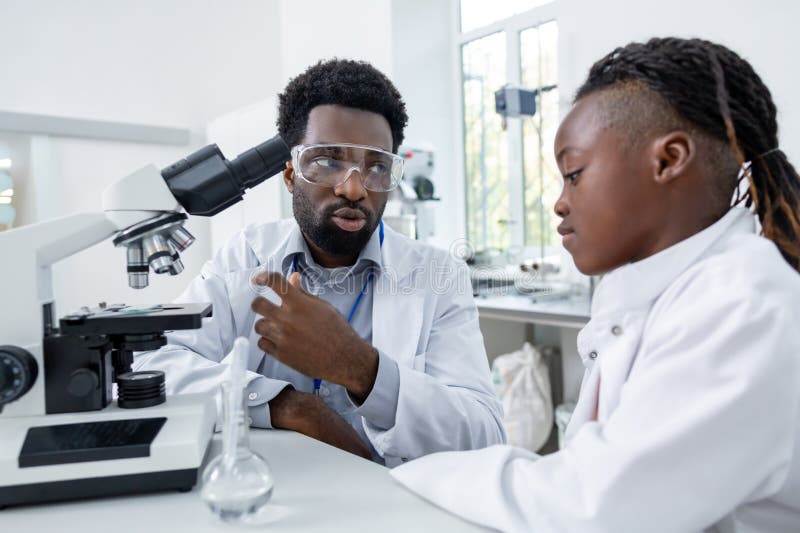 Teacher Showing Experiment Results Student Using Microscope Stock Photos - Free & Royalty-Free ...